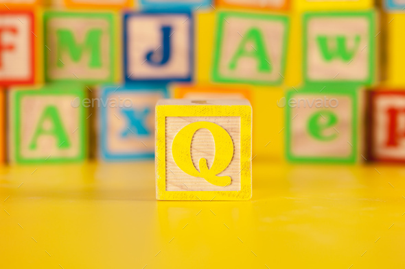 Photograph of colorful Wooden Block Letter Q Stock Photo by FabrikaPhoto