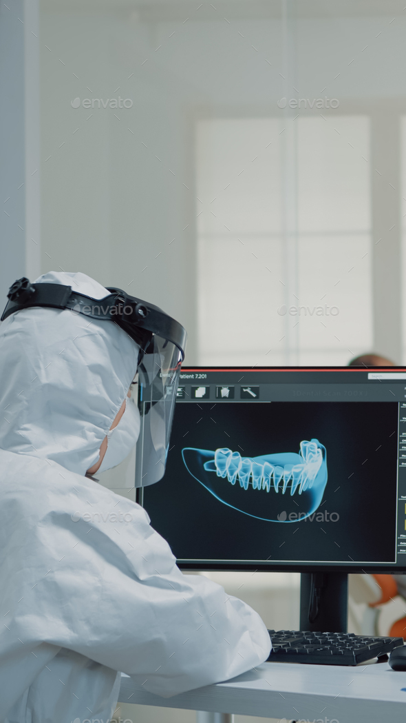 Orthodontists analyzing virtual teeth animation at oral clinic Stock ...