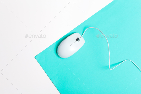 Computer mouse on a turquoise paper background Stock Photo by FabrikaPhoto