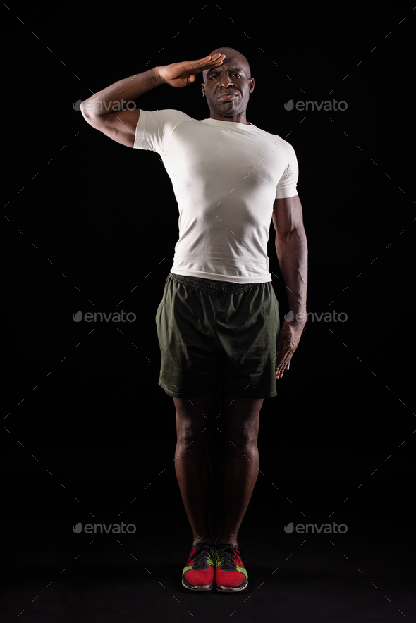 man greeting at camera with a military salute in an act of honor and ...