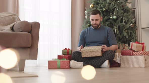 Man Opening Box with Light Shining Inside, Stock Footage | VideoHive