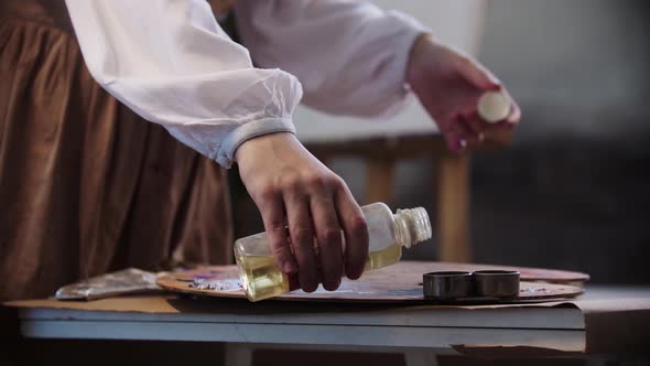 Young Woman Artist Pouring Solvent for Paint in the Compartment, Stock ...