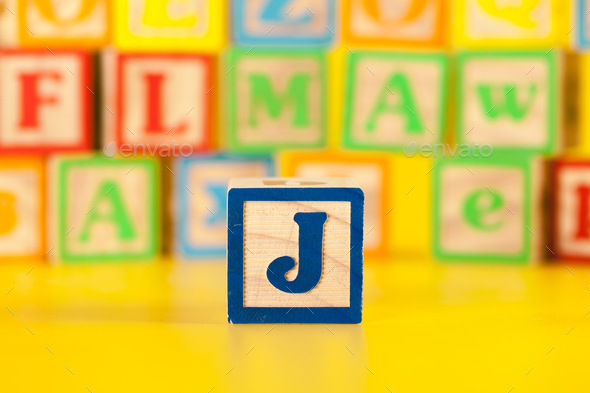 Photograph of colorful Wooden Block Letter J Stock Photo by FabrikaPhoto