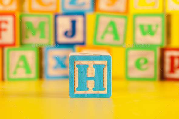 Photograph of colorful Wooden Block Letter H Stock Photo by FabrikaPhoto