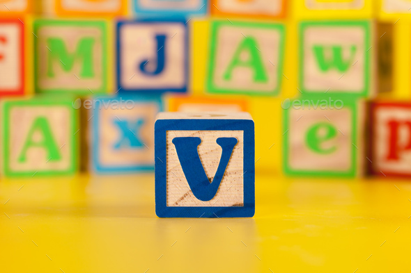 Photograph of colorful Wooden Block Letter V Stock Photo by FabrikaPhoto