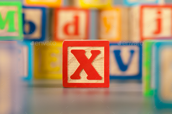 Photograph of colorful Wooden Block Letter X Stock Photo by FabrikaPhoto