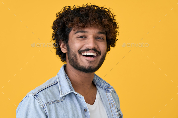 Happy young indian guy laughing isolated on yellow background. Headshot ...