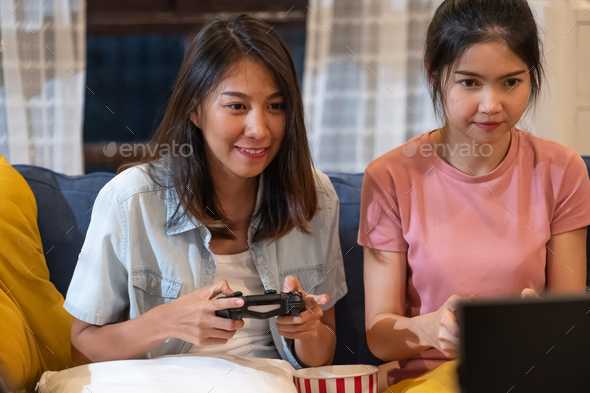 happy friends playing game on sofa at home nigth time with fun Stock ...