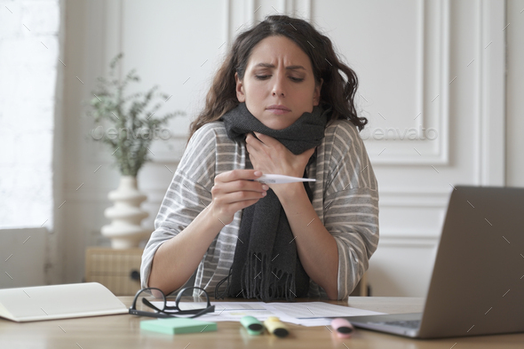 Worried young hispanic woman office worker with fever sitting workplace ...