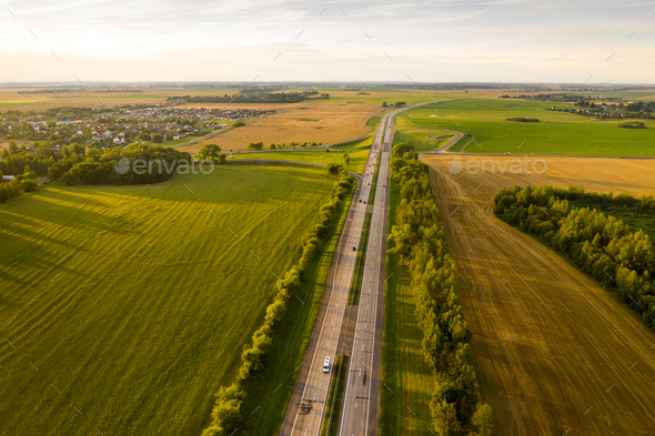Top view of the road with cars and fields around the road.Fields and ...