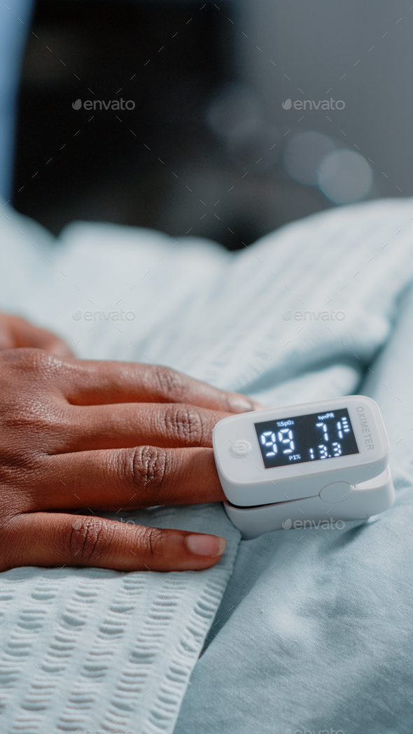 Close up of oximeter on finger of patient with illness Stock Photo by ...