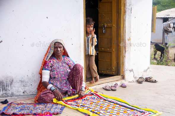 Tribal woman working her traditional handicrafts by embroidering ...