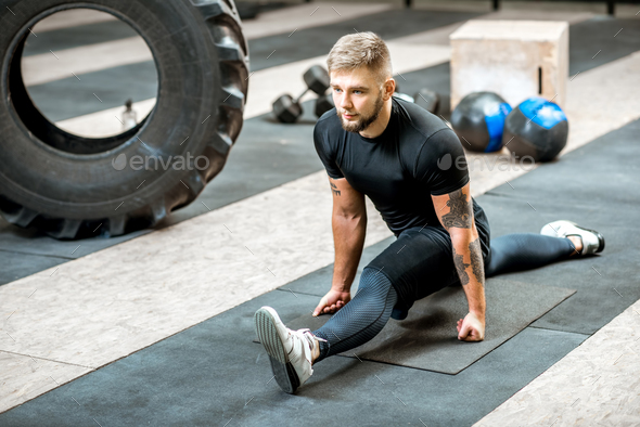 Man stretching in the gym Stock Photo by RossHelen | PhotoDune