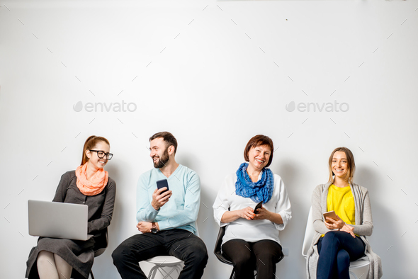 People with gadgets on the white background Stock Photo by RossHelen