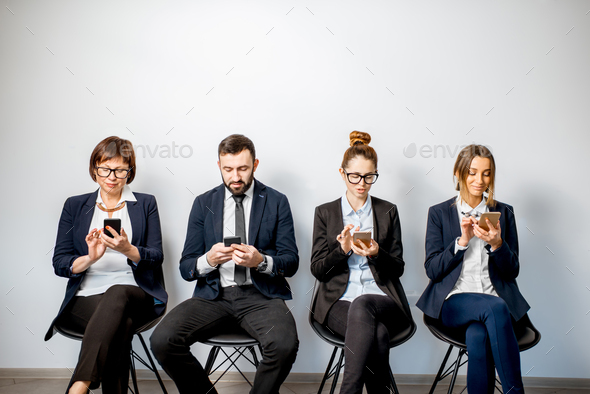 Business people sitting in a row Stock Photo by RossHelen | PhotoDune