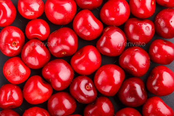 Cherry pattern on black background. top view. Stock Photo by uladzimirz