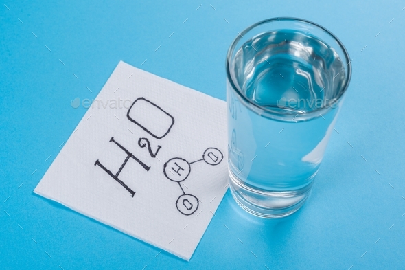 Glass with water, napkin with water formula, blue background. Stock ...