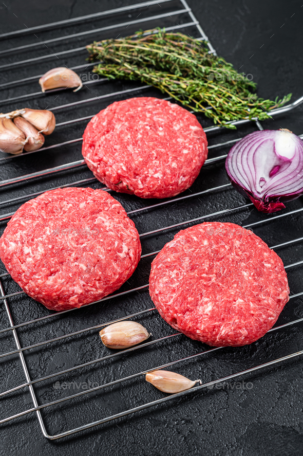 Organic raw ground beef, round patties for homemade burger. Black ...