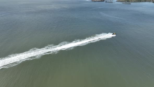 An aerial view over Gravesend Bay in Brooklyn, NY as a jet ski rider ...