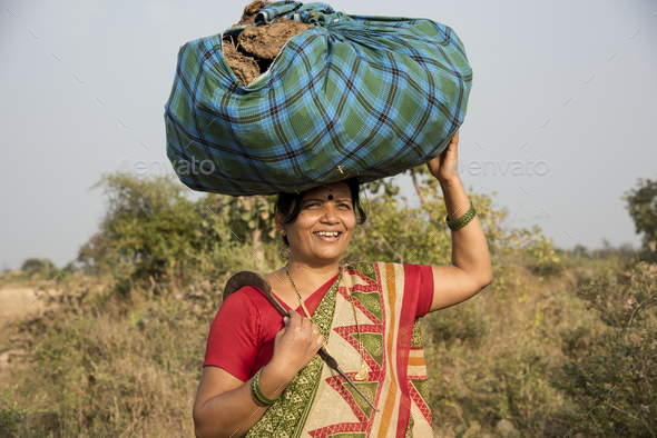 Rural Indian women carry load of cow dung on her head. Stock Photo by ...