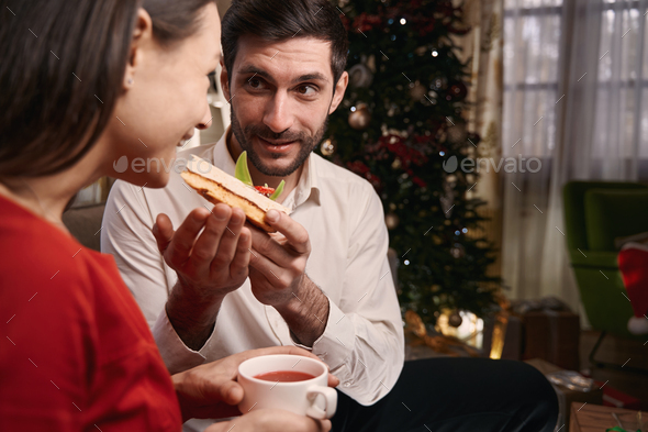 Man holding piece of cake and inviting his girlfriend to eat it Stock ...