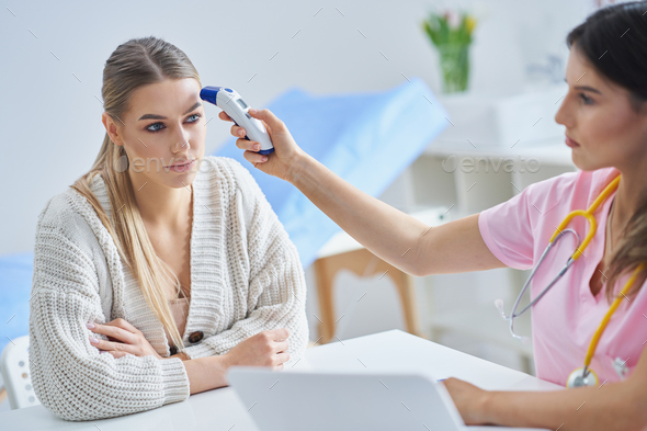 Doctor explaining diagnosis to her female patient Stock Photo by macniak