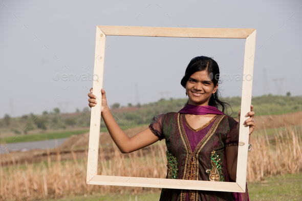 Young beautiful Indian girl with frame on nature background. Stock ...