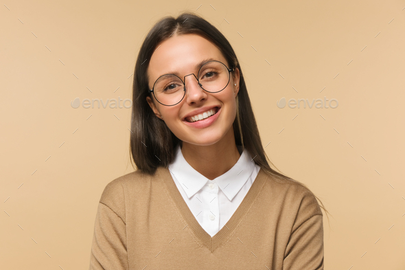 Good-looking European girl pictured on beige background in casual ...