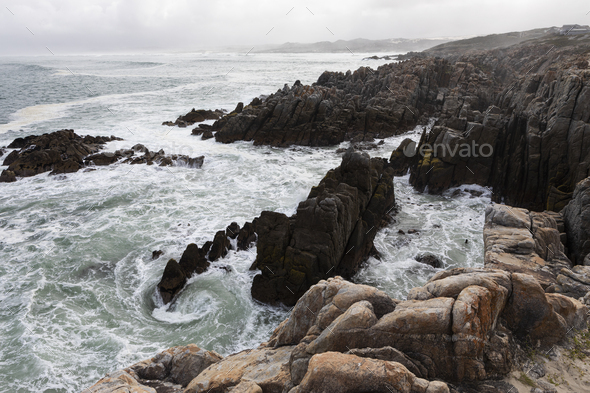 Jagged rocks and the rocky coastline of the Atlantic at De Kelders ...