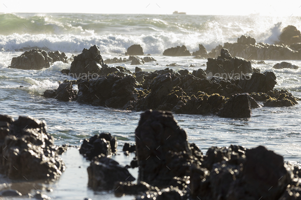 Jagged rocks and waves breaking on shore on the Atlantic coastline ...