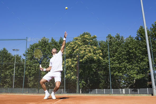 Tennis player serving a tennis ball during a tennis match Stock Photo ...