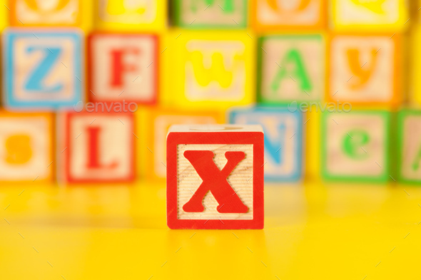 Photograph of colorful Wooden Block Letter X Stock Photo by FabrikaPhoto