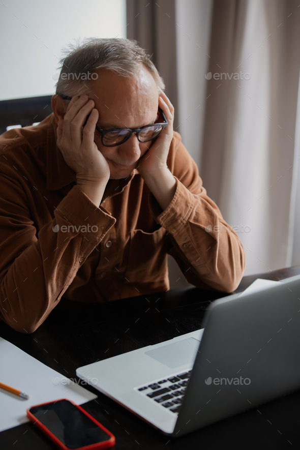 Old man in eyeglasses using laptop computer at home. Stock Photo by ...