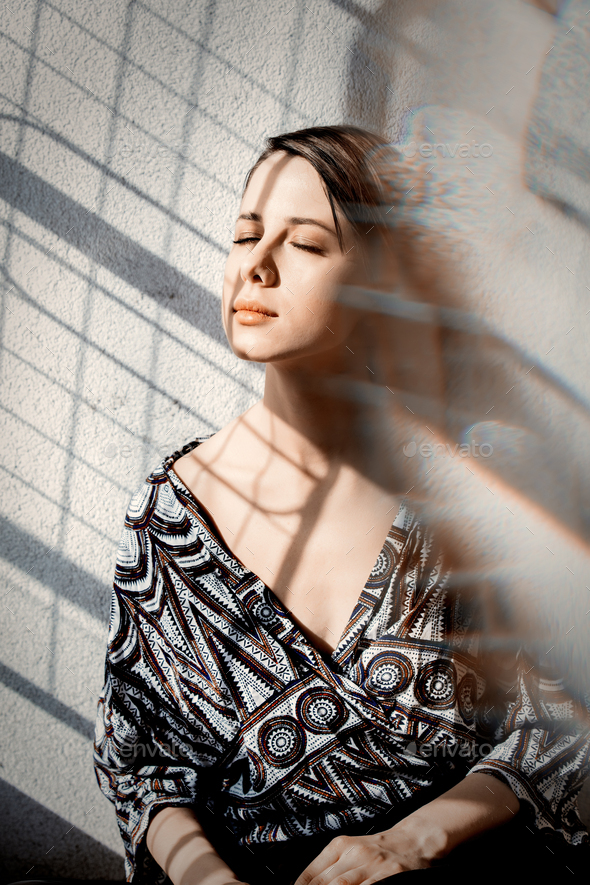 woman in beautiful clothes with glass distortions and shadows on her ...