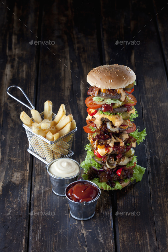 Extra large hamburger with fries, mayonnaise and ketchup Stock Photo by ...