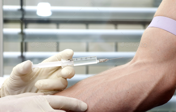 Man receiving injection in arm Stock Photo by westend61 | PhotoDune