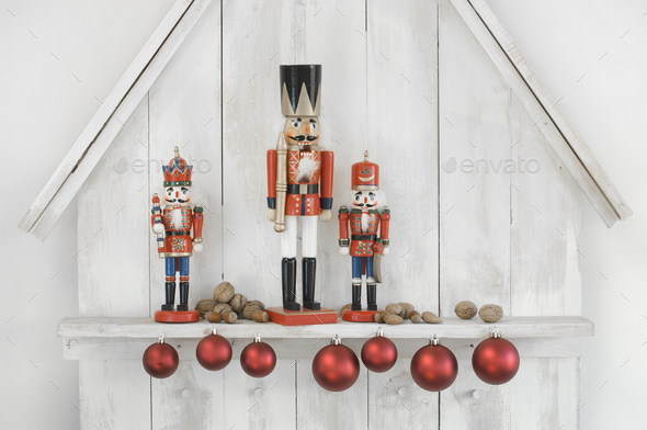Christmas decoration with three nutcrackers, Christmas baubles and nuts ...