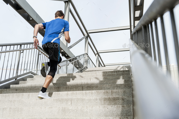Man running up stairs Stock Photo by westend61 | PhotoDune