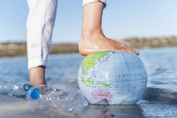 Man's foot on Earth beach ball, close-up Stock Photo by westend61 ...