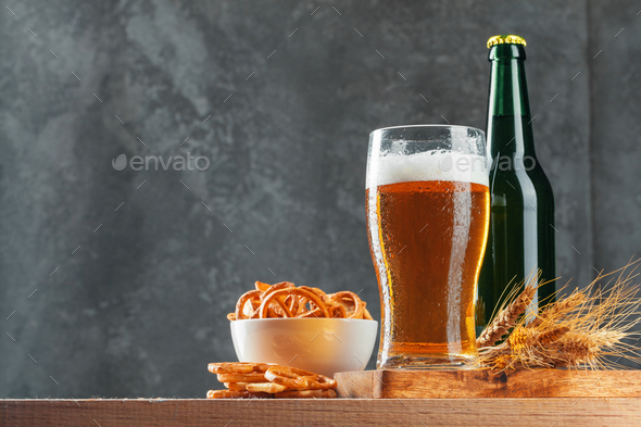Lager beer and snacks on stone table. Cracker, chips side view Stock ...
