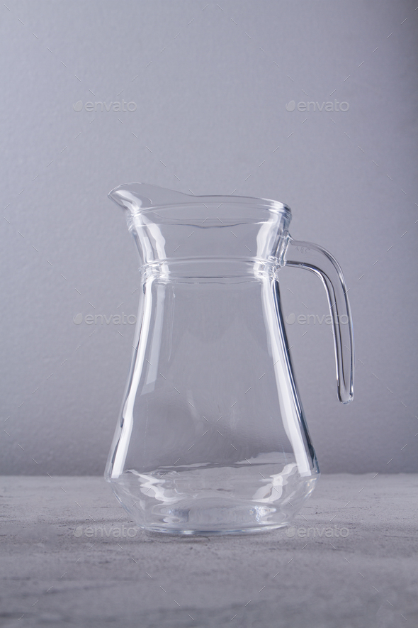 Transparent glass jug on a white background. Stock Photo by stockfilmstudio