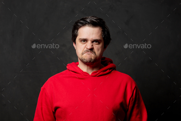 White angry guy in red sweatshirt on dark background Stock Photo by ...