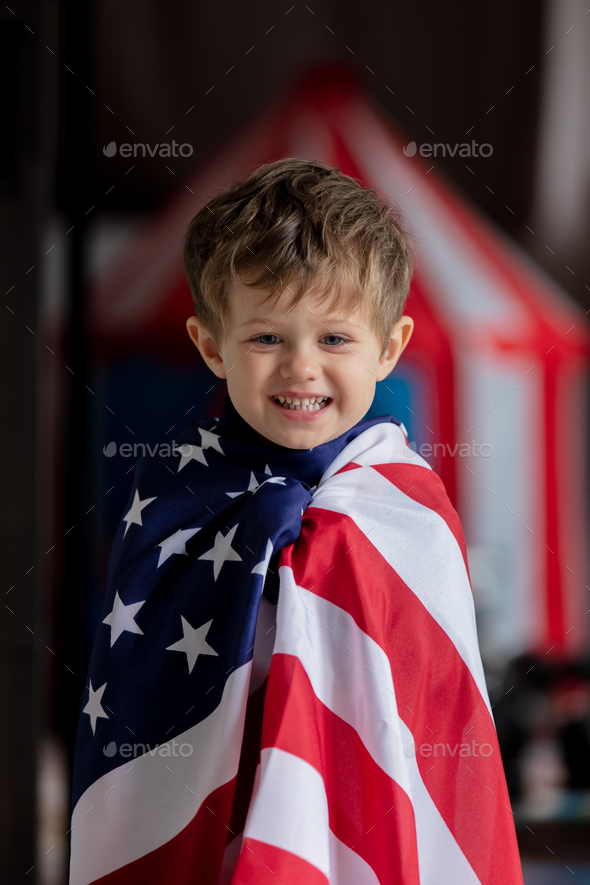 Little kid play with USA flag at home alone Stock Photo by Masson-Simon