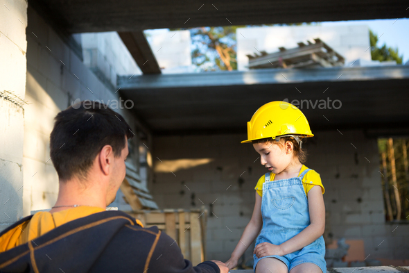 Dad and daughter are at construction site of their future home Stock ...