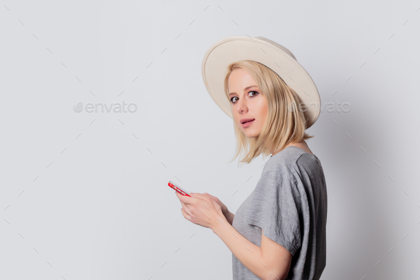 Beautiful blonde woman using mobile phone on white background Stock ...