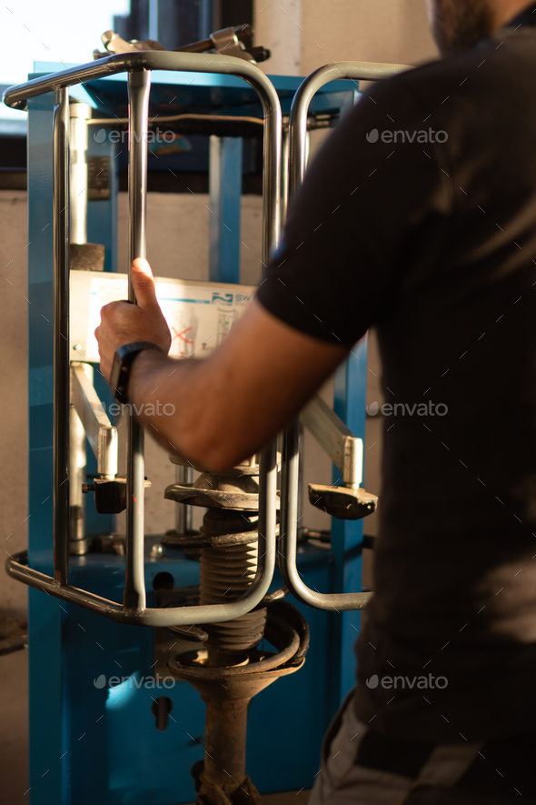Check of car suspension system by car mechanic Stock Photo by Pasanheco