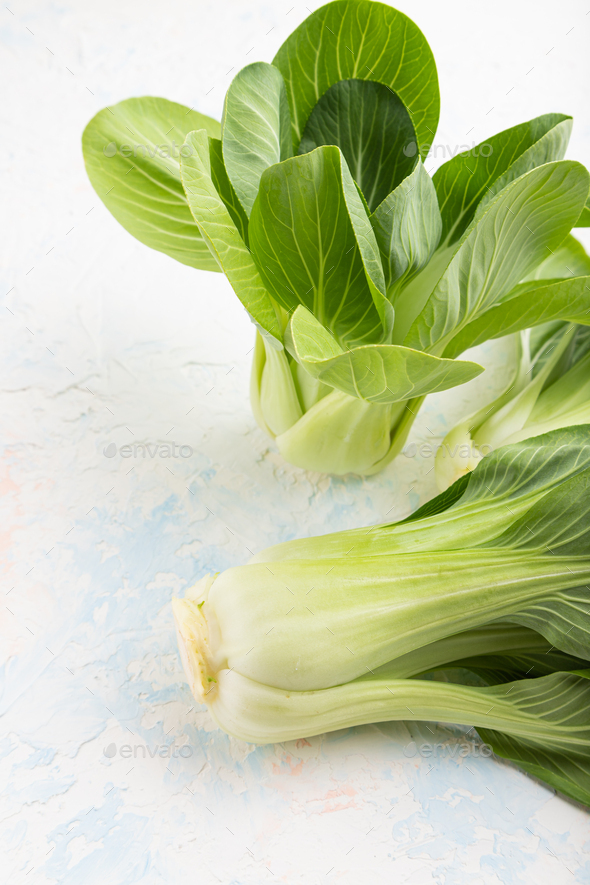 Fresh green bok choy or pac choi chinese cabbage on a white concrete ...