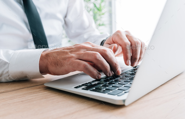 White collar worker typing laptop computer keyboard at office desk ...