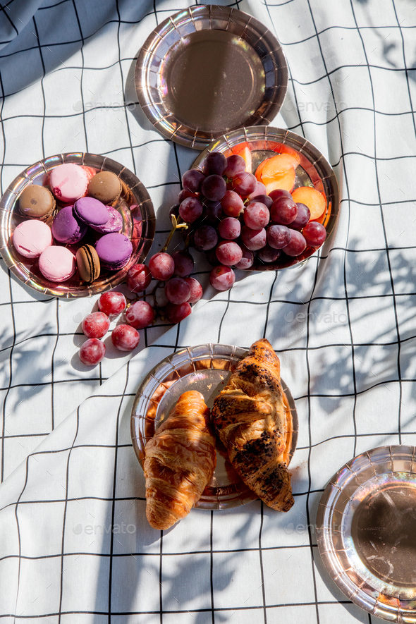Grape, macarons and croissants on plates Stock Photo by Masson-Simon