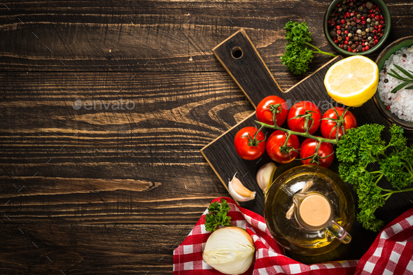 Food cooking background on wooden kitchen table. Stock Photo by Nadianb